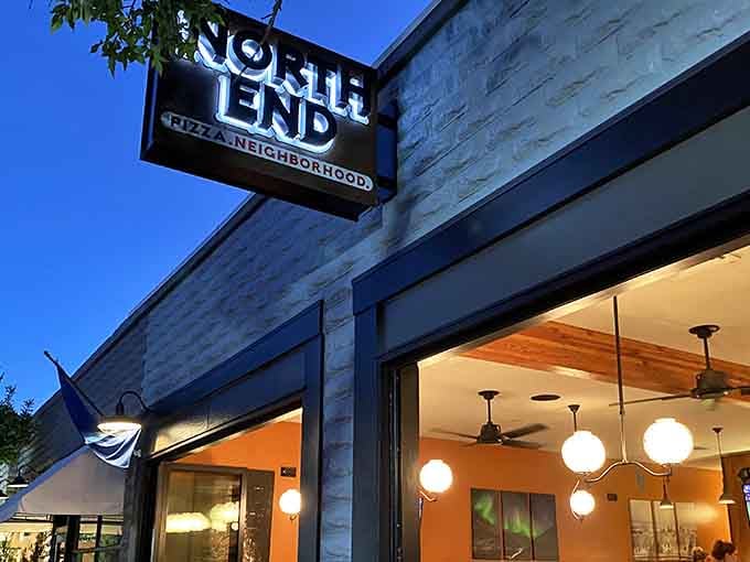 The North End sign glows like a beacon for pizza lovers, promising neighborhood vibes and slices of pure joy.