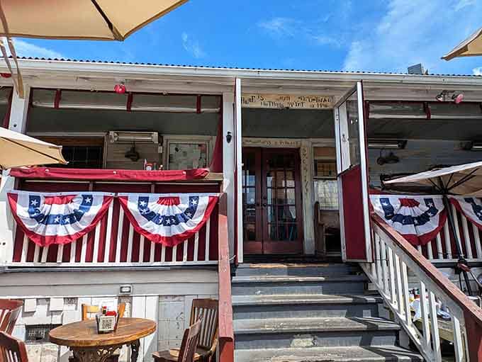 That patriotic porch wrapped in red, white, and blue bunting screams classic American beach town charm and hospitality.