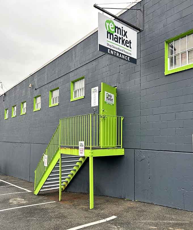 That neon-green stairway to thrifting heaven looks like something from a hip Brooklyn loft, not your typical secondhand shop.