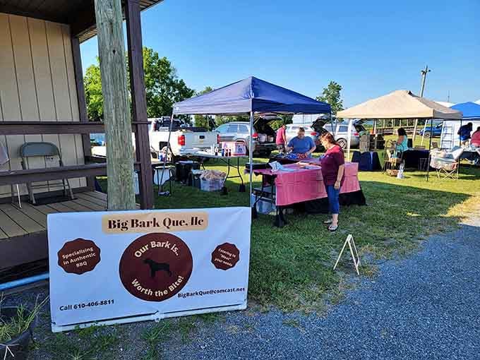 That "Big Bark Que" sign promises delicious smoked meats while shoppers browse nearby tables loaded with weekend treasures.