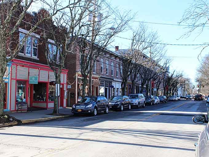 Tree-lined sidewalks create natural shade tunnels perfect for leisurely strolls past antique shops and hidden treasures.
