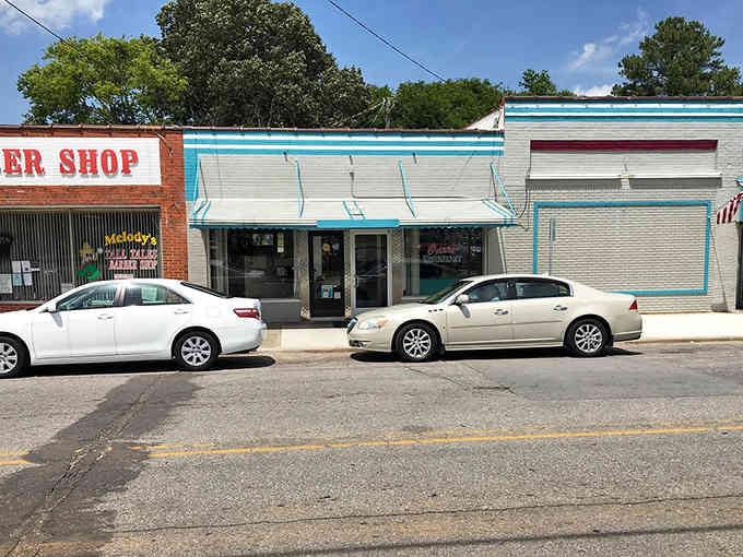 Classic barbershop poles and vintage signage transport you to the Eisenhower era instantly.