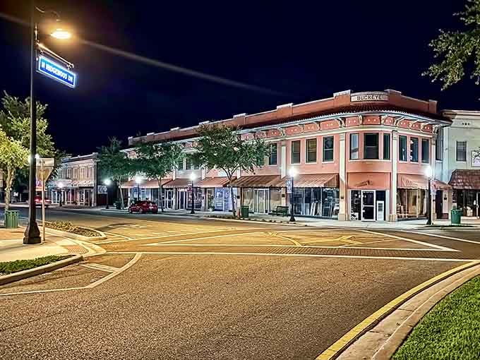The evening lights illuminate storefronts along empty streets, peaceful as a Sunday morning in simpler times.