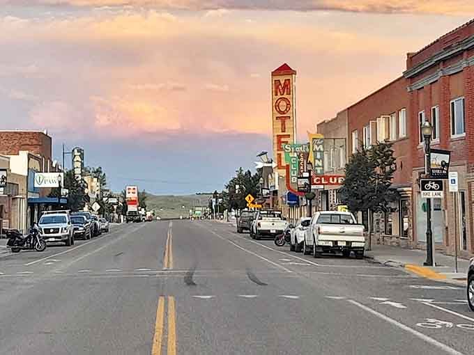 Shelby's main street at dusk, where the neon MOTEL sign glows like a beacon from simpler times. Small-town Montana charm in full display.