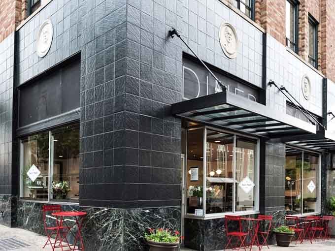 Sleek black tiles and modern lines prove that contemporary design and classic diner comfort can absolutely coexist beautifully.