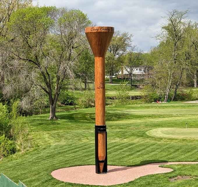 The World's Largest Golf Tee stands proudly on its green patch, making regular tees look like toothpicks by comparison!