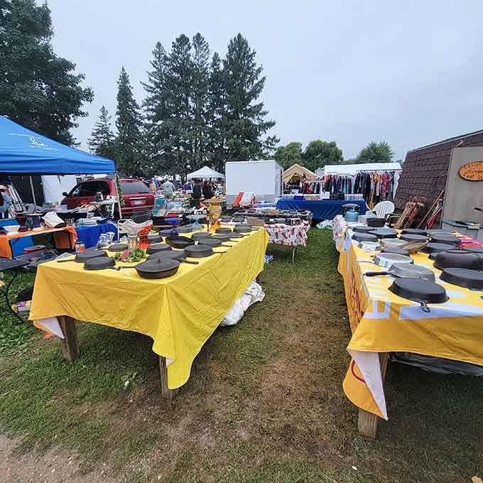Those bright yellow and white tablecloths showcase cast iron skillets like they're precious gems, and honestly, they are.