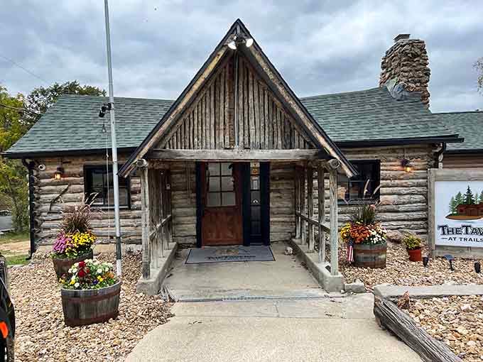 This weathered log cabin with its stone chimney looks like something from a frontier postcard, promising hearty tavern fare inside.