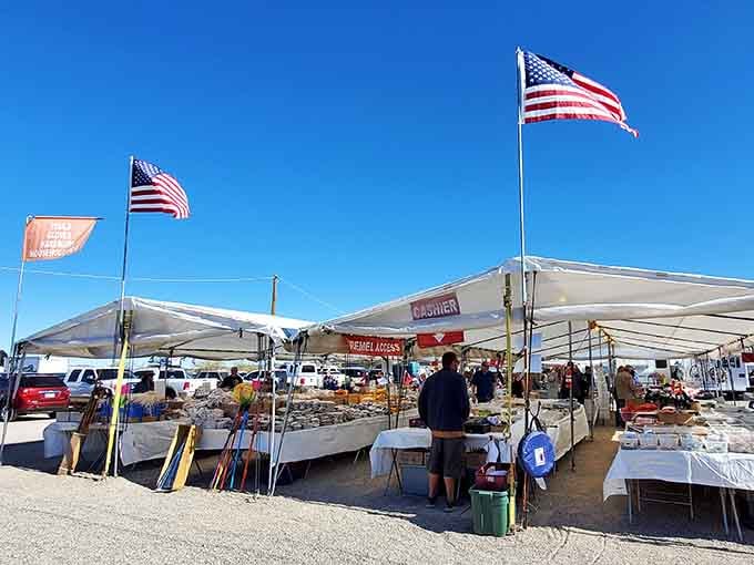 American flags wave proudly above vendor tents where community spirit meets commerce under wide open skies.