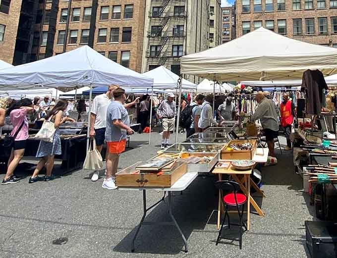 Browsers weave between vendor stalls in this bustling outdoor marketplace where every table tells a story.