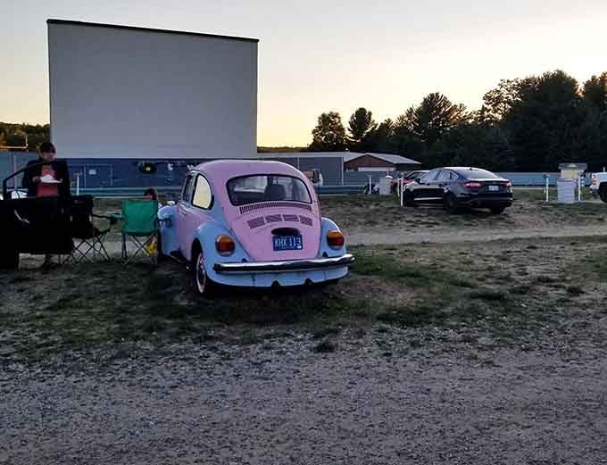 That purple VW Bug parked perfectly captures the timeless charm of watching films under the stars together.