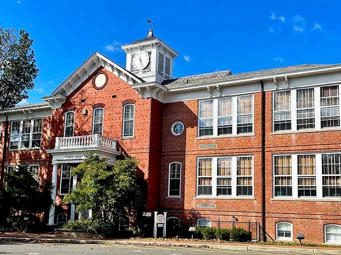 The town clock tower watches over brick facades that have anchored this community through centuries of American life.