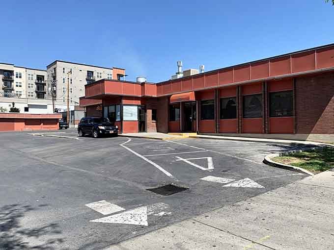 Behind this unassuming orange facade lurks the kind of burger magic that turns first-time visitors into lifelong devotees.