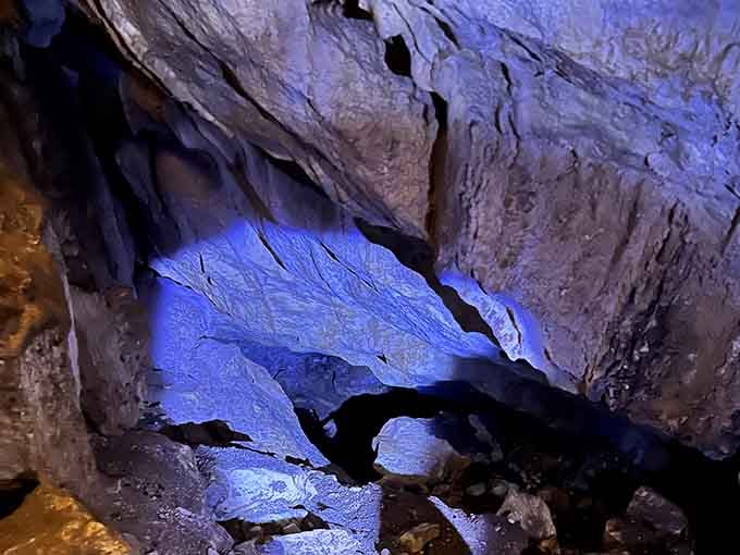 That ethereal blue glow transforms rough volcanic rock into something from a science fiction movie set.