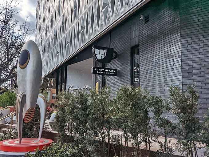 A quirky sculpture stands guard outside this modern coffee haven where pages and espresso create the perfect pairing.