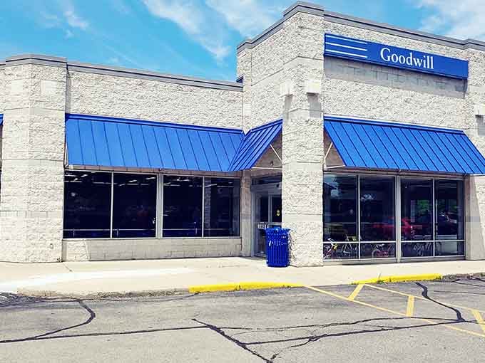 Bright blue pops against stone at this Goodwill location &ndash; like a well-dressed friend inviting you in for coffee and bargains.