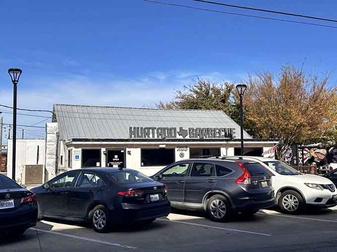 A humble white building with a bold sign that promises (and delivers) barbecue worth crossing county lines to find.