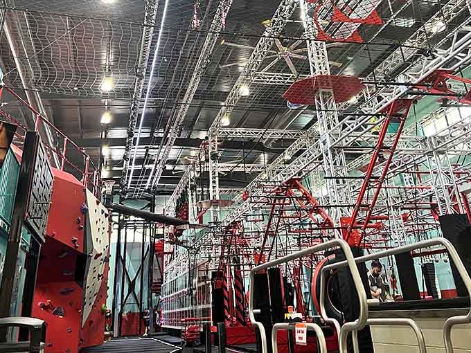 This massive indoor rope course at OC Aerial stretches like a colorful spider web designed by someone who loves thrills.