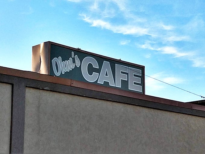 The rooftop sign catches golden hour light, marking this Main Street spot as a Mandan dining institution.