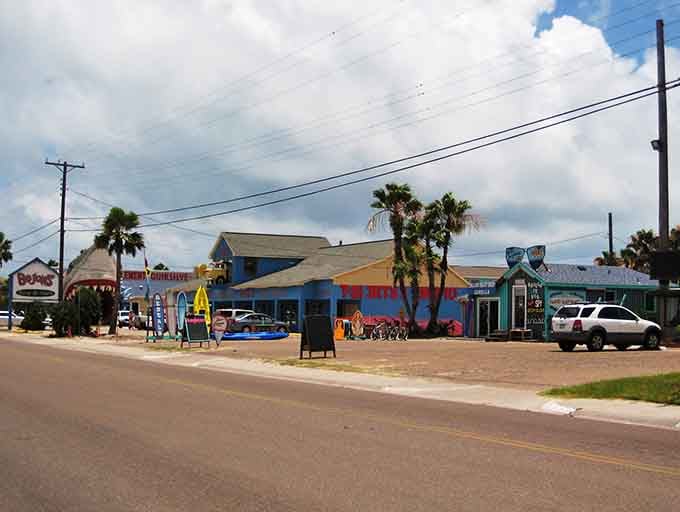 Colorful beach shops line the street like a rainbow of possibilities, each one promising coastal treasures inside.