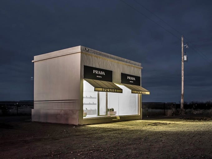 The stark white building glows against storm clouds, creating a scene straight out of a Salvador Dali painting.