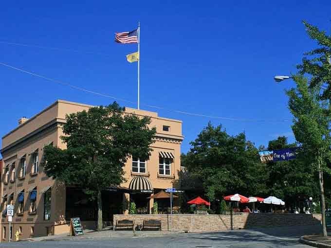 Striped awnings and outdoor seating invite you to linger where community still means knowing your neighbor's name well.