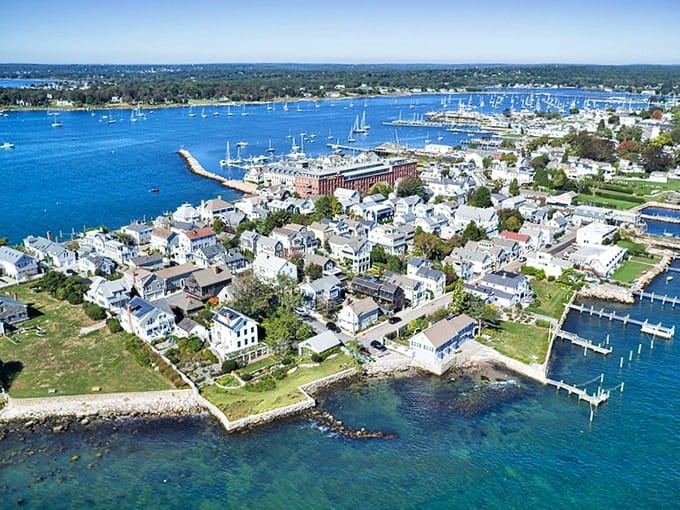 Sailboats dot the harbor like confetti on blue water, creating a postcard scene that never gets old.