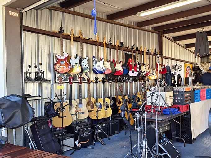 Electric and acoustic guitars line the wall like a rock and roll hall of fame waiting for their next owner.