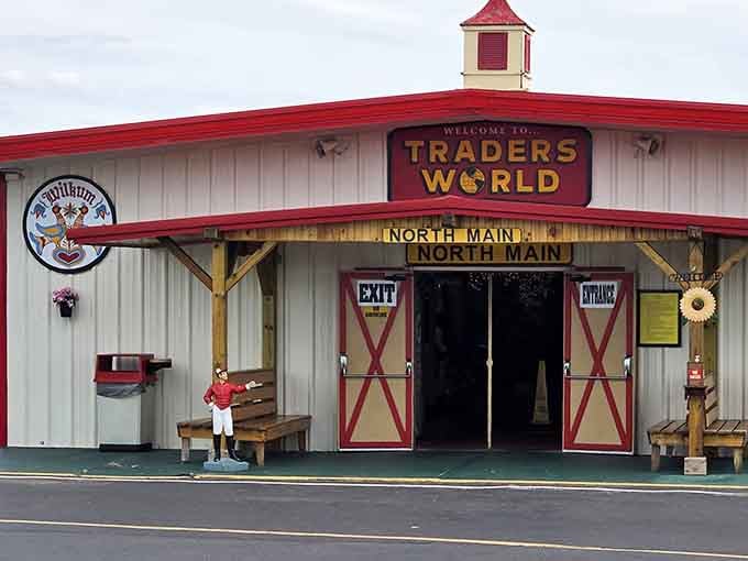 The charming barn-style entrance with red doors invites you into a world of unexpected discoveries.