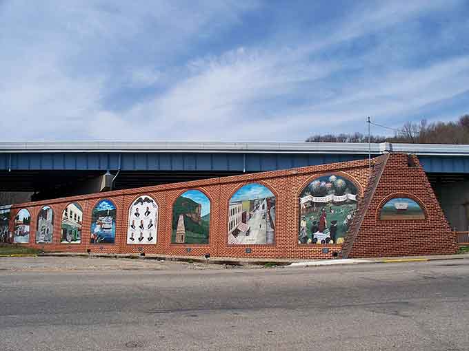 Colorful murals celebrate Wellsville's heritage beneath a bridge, telling stories that money can't buy.