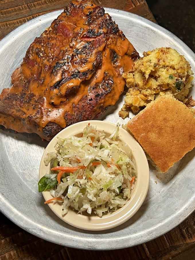 Ribs glazed to perfection, flanked by corn pudding and slaw that could steal the spotlight themselves.