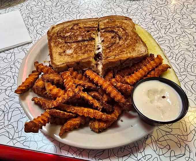 A Reuben sandwich paired with crispy fries delivers the kind of lunch that makes afternoons worthwhile.