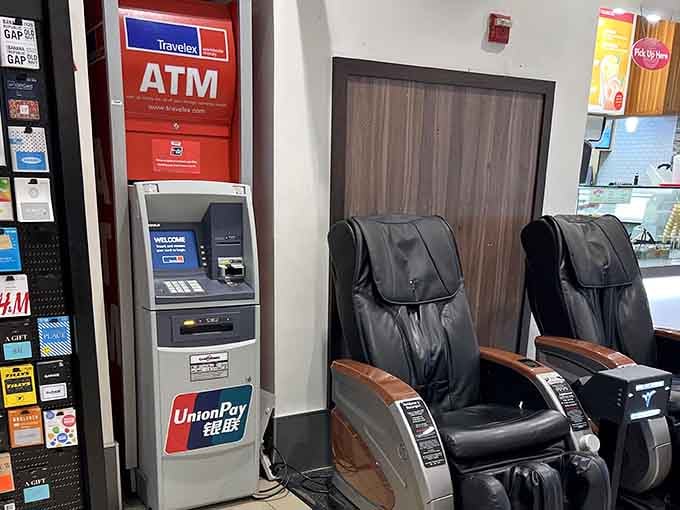 Massage chairs and an ATM side by side: rest your feet while accessing funds for more deals.