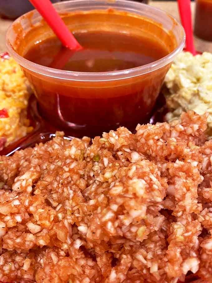 This isn't your mayo-drenched coleslaw from the supermarket deli. This finely-chopped, vinegar-kissed slaw cuts through rich barbecue like a well-timed punchline.