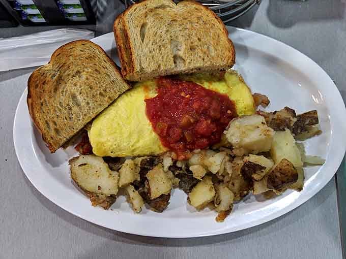 This omelet is so perfectly folded it could teach geometry lessons, stuffed with enough fillings to fuel your entire day.