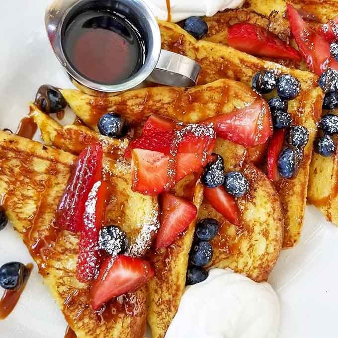 French toast topped with fresh berries and syrup&mdash;breakfast so pretty it almost distracts from the bacon. Almost.