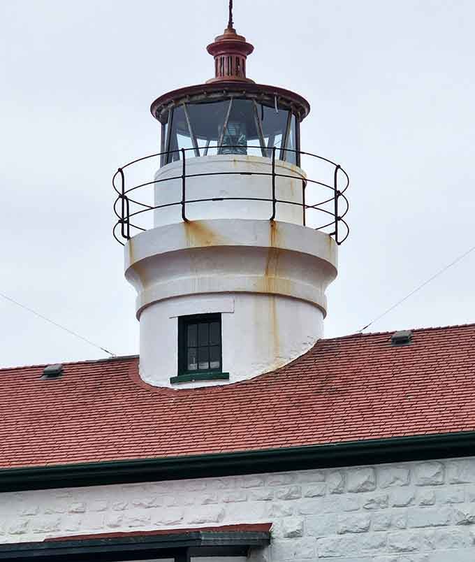 The lighthouse tower stands ready for its close-up, looking exactly like every lighthouse you've ever dreamed about visiting.