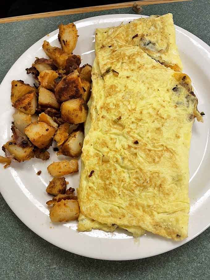 That omelet is so generously stuffed, it's practically bursting at the seams with flavor and perfectly crispy home fries.