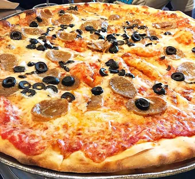 This isn't just pizza, it's a mathematical equation where deliciousness multiplied by size equals pure, unapologetic joy on a pan.