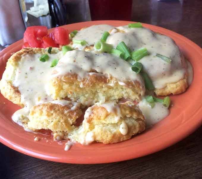 Biscuits swimming in sausage gravy with green onion confetti&mdash;Southern comfort that doesn't just stick to your ribs, it hugs them.