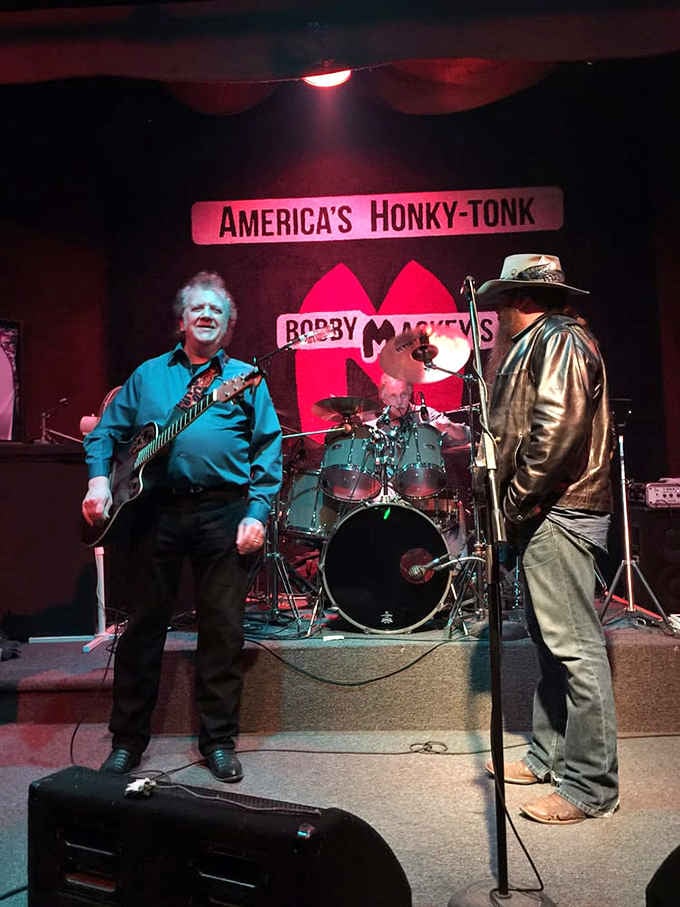 Musicians perform under moody lighting, where the audience might include more than just the folks you can see.