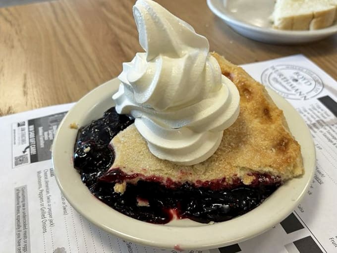Black raspberry pie topped with whipped cream: proof that sometimes the simplest presentations are the most devastating.