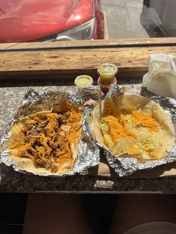 Breakfast tacos worth setting your alarm for – one loaded with savory meat, the other with eggs and cheese, both wrapped in that signature handmade tortilla.