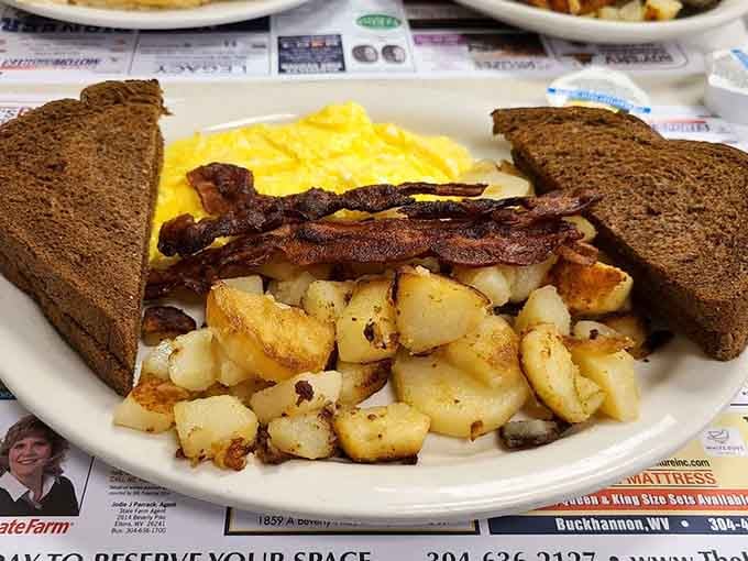 Breakfast perfection on a plate—where the bacon is crispy, the eggs are fluffy, and the toast stands ready for its butter baptism.