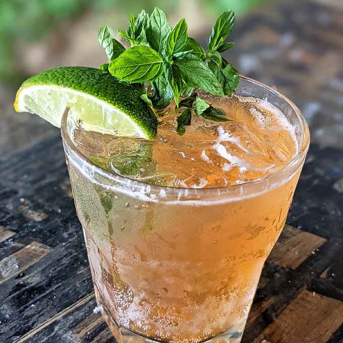 Fresh herbs and citrus make this cocktail look like summer decided to take liquid form and chill out.