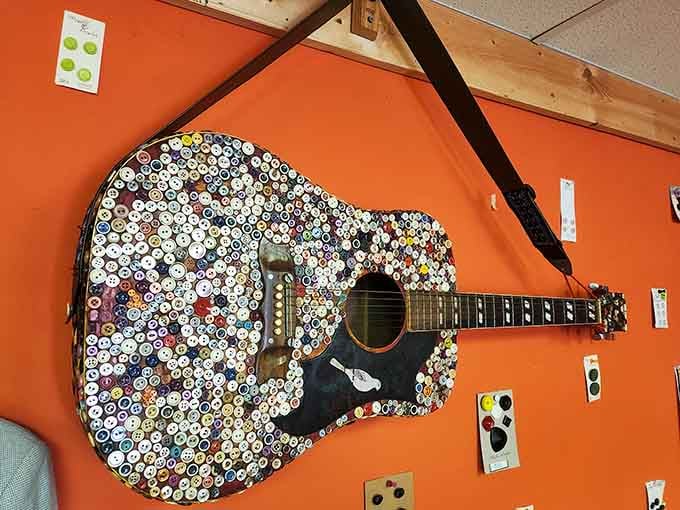 Strumming this button-adorned guitar would give new meaning to the phrase "playing with feeling and texture."