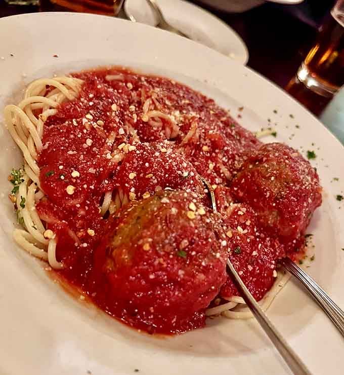 Meatballs so generous they could have their own zip code, blanketed in sauce that dreams are made of.