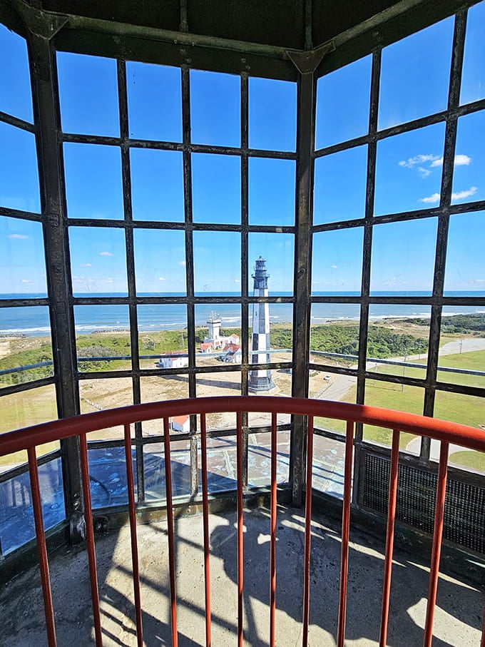 Looking up through the lantern room windows, where lighthouse keepers once tended flames that saved countless lives at sea.