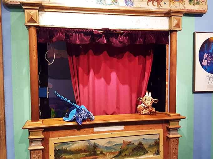 Red velvet curtains frame a tiny stage where hand-carved puppets wait to enchant the next wide-eyed audience member.