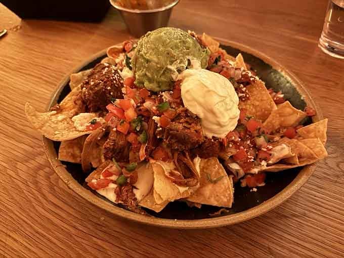 These carnitas nachos are piled so high, they're practically an edible mountain range worthy of Colorado itself.